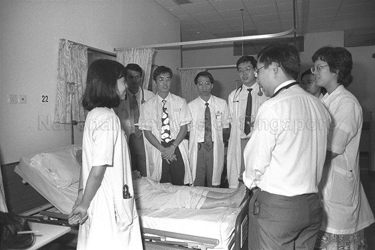 View of medical personnel gathering around a patient at