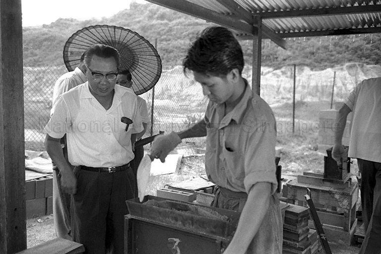MINISTER FOR NATIONAL DEVELOPMENT LIM KIM SAN OBSERVING A