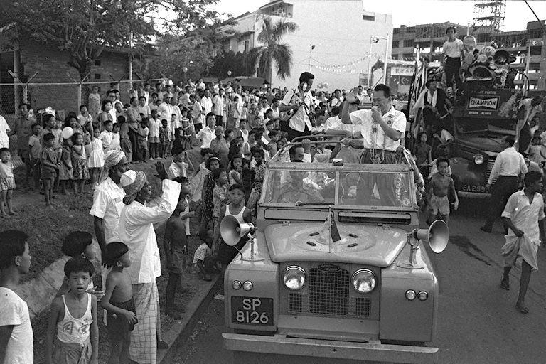 Prime Minister Lee Kuan Yew on a campaign vehicle travelling