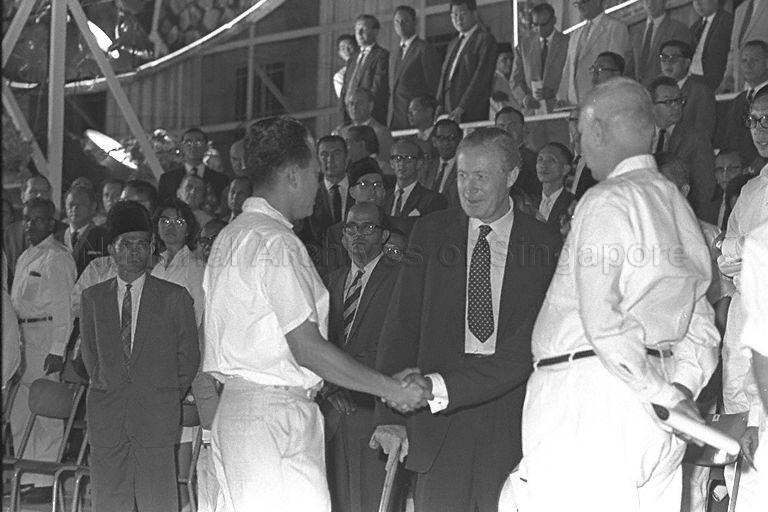 Prime Minister Lee Kuan Yew (back to camera) exchanging