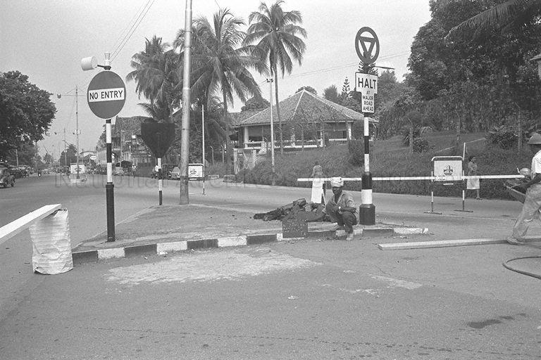 Public Works Department (PWD) worker holding chalkboard with