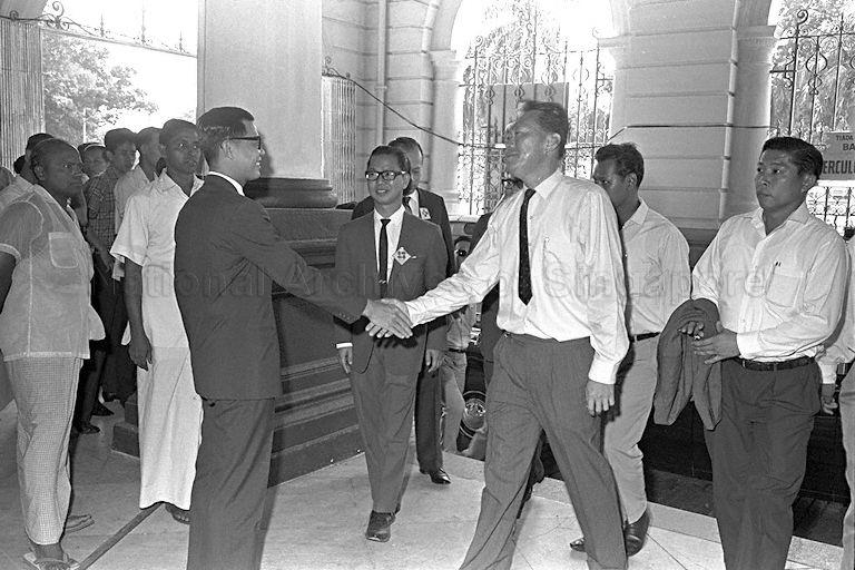 Prime Minister (PM) Lee Kuan Yew being welcomed by Minister