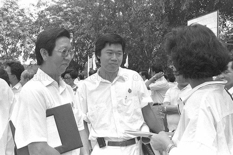 People's Action Party (PAP) members speaking to the media at