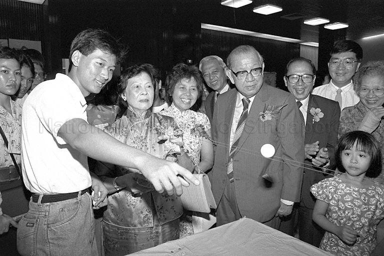 First Lady Mrs Wee Kim Wee trying her hand at a game during