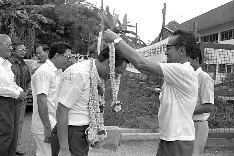 Minister without Portfolio Lim Chee Onn being garlanded when