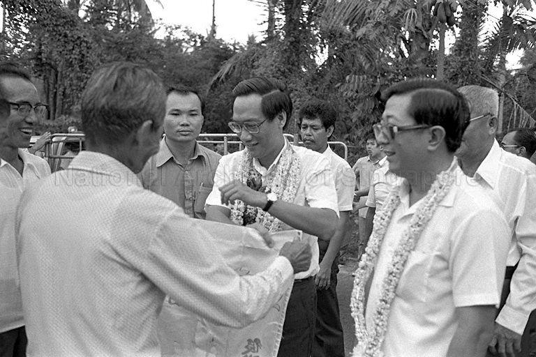 Minister without Portfolio Lim Chee Onn receiving silk