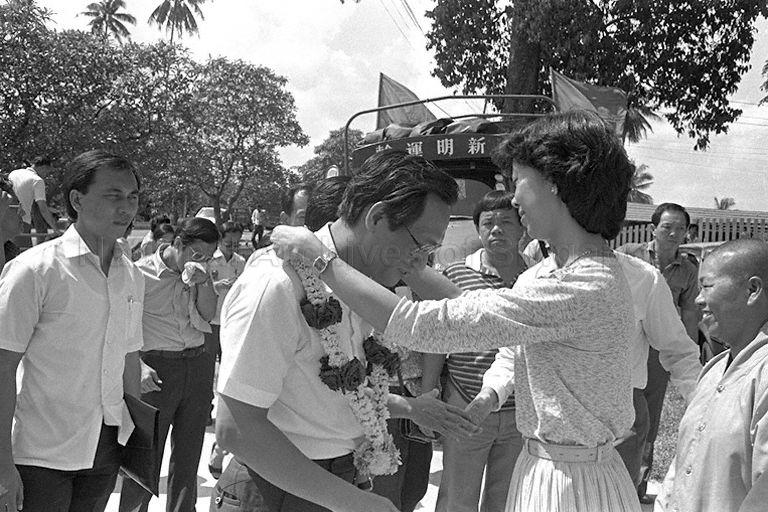 Minister without Portfolio Lim Chee Onn being garlanded when