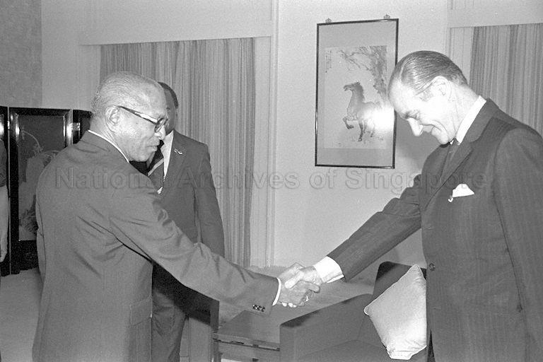 President Devan Nair shaking hands with member of