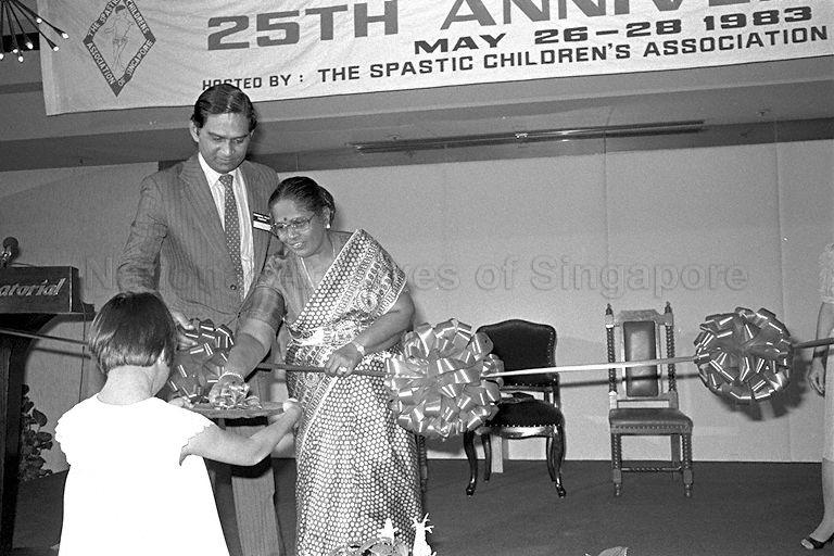 First Lady Mrs Devan Nair cutting ribbon to open seminar on