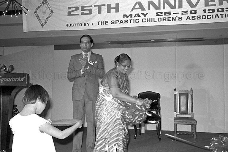 First Lady Mrs Devan Nair cutting ribbon to open seminar on