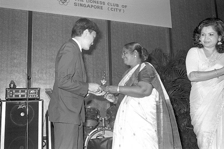 First Lady Mrs C V Devan Nair (second from right) presenting