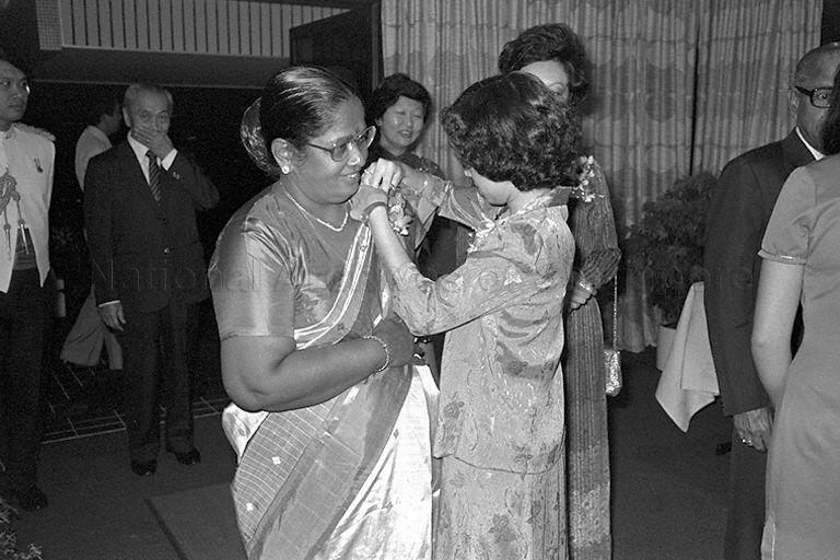 First Lady Mrs Devan Nair receiving a corsage upon arrival