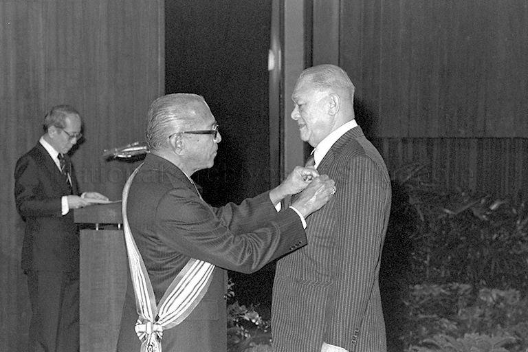 President C V Devan Nair pinning the Meritorious Service