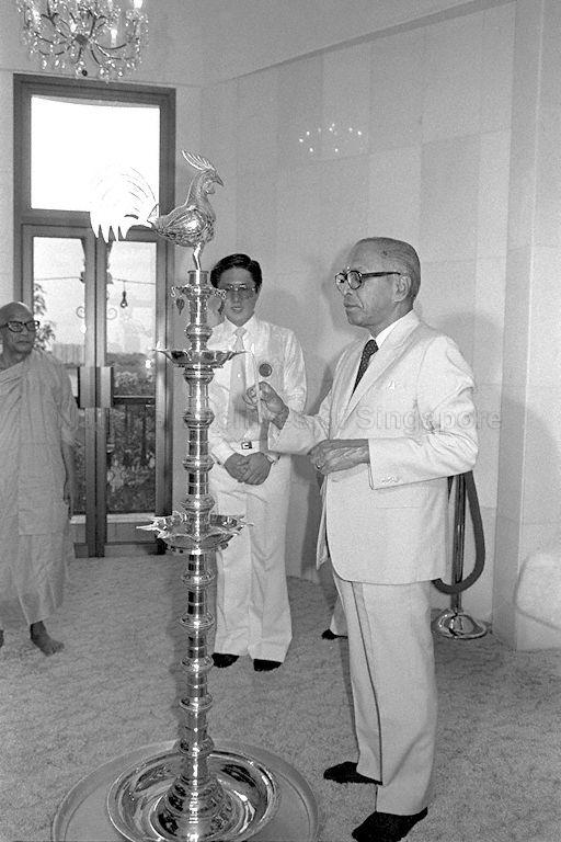President C V Devan Nair lighting a ceremonial flame at