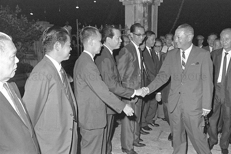 Minister for Defence Lim Kim San being greeted on his