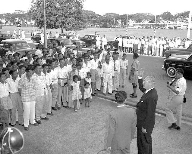 British Prime Minister Harold Macmillan waving to crowd