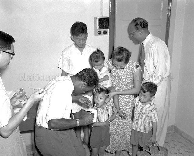 A child receiving a spoonful of Sabin vaccine and syrup at