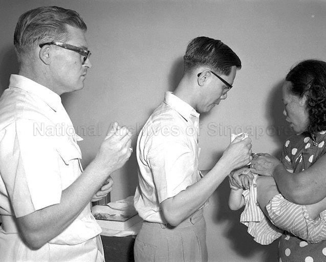 A child receiving a spoonful of Sabin vaccine and syrup at