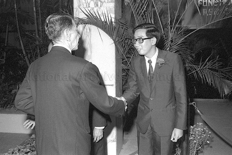 President Dr Benjamin Sheares (back to camera) going through