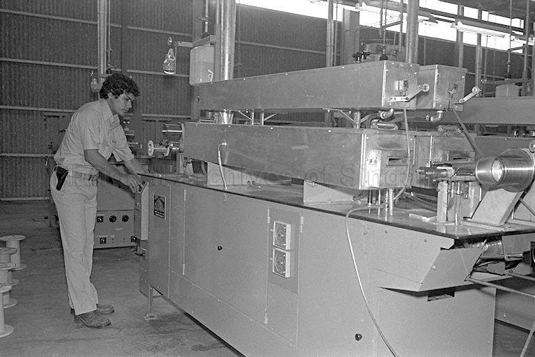 Employee at work in factory of Sumiden Singapore Pte Ltd at