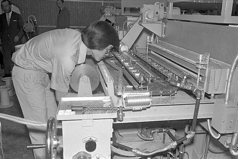 Employee at work in factory of Sumiden Singapore Pte Ltd at