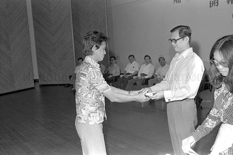 Minister for Labour Ong Pang Boon presenting scrolls during
