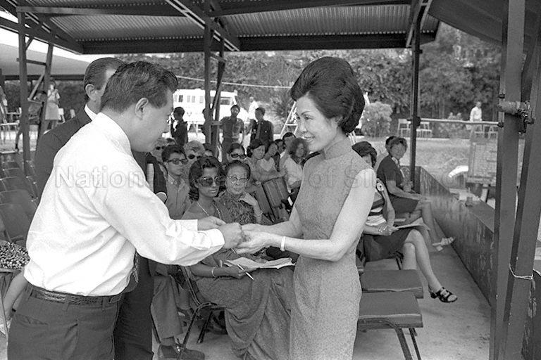 First Lady Mrs Benjamin Henry Sheares (right) receiving two