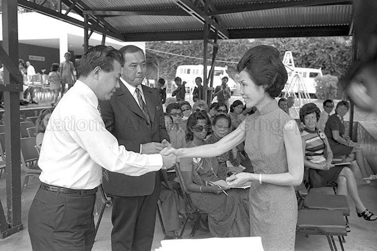 First Lady Mrs Benjamin Henry Sheares (right) receiving two