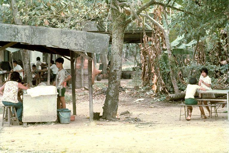 A SCENE OF KAMPONG LIFE BEFORE RESETTLEMENT TO HOUSING BOARD