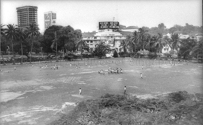 Raffles Institution - School field, with the Peninsula Hotel