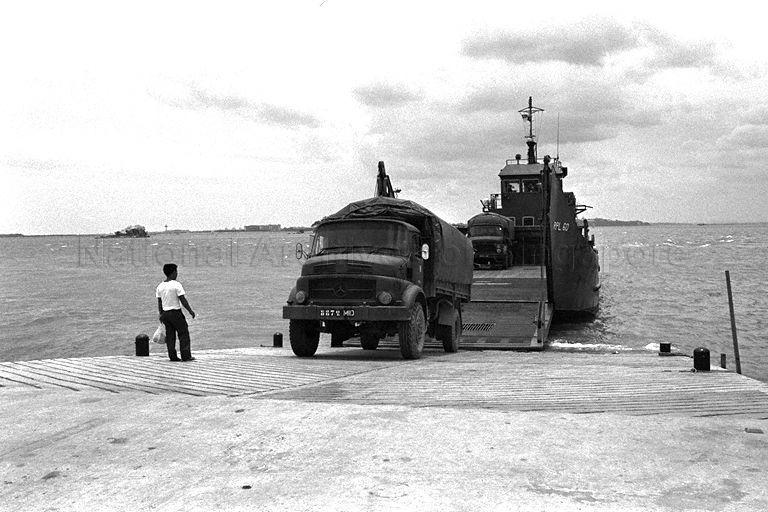 Pulau Tekong -- View of army trucks moving down from naval