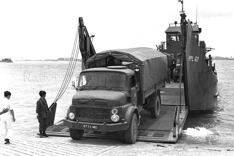 Pulau Tekong -- View of army truck backing up naval ramp-