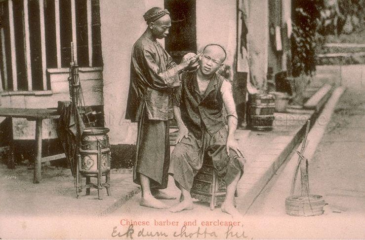 A Chinese street barber offering barbering services as well