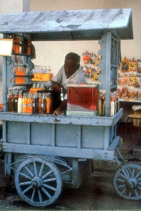 HAWKER SELLING DRINKS FROM CART