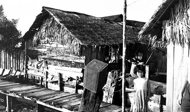 Attap roofed houses at Kallang Basin with wooden plank walls