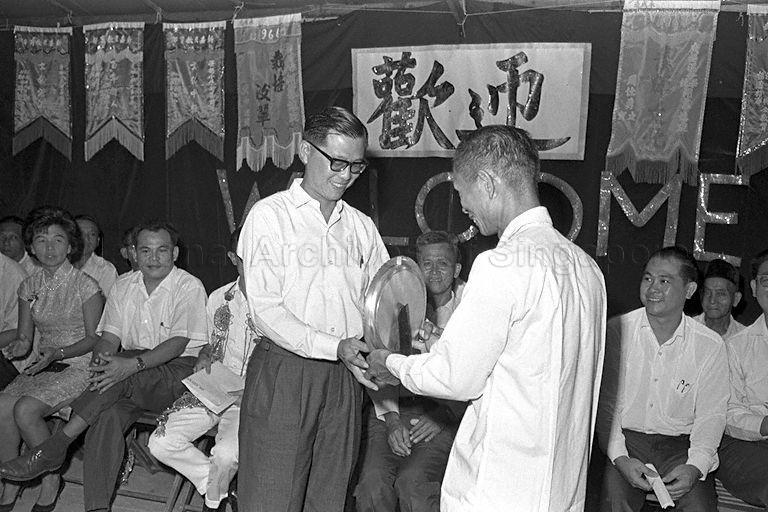 Minister for Education Ong Pang Boon (left) receiving token