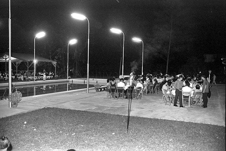 GUESTS AT A DINNER BY THE PYRAMID CLUB'S SWIMMING POOL AFTER