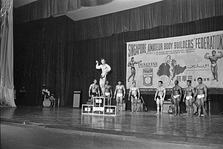 A bodybuilding contestant posing on stage during "Mr