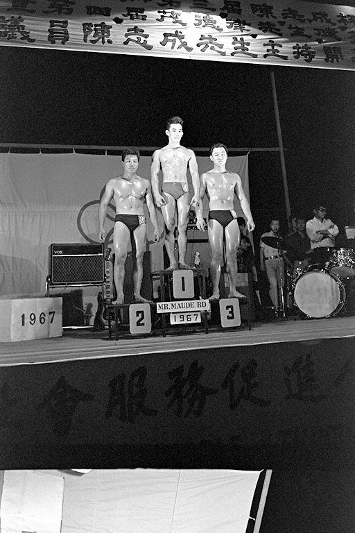 Bodybuilders standing on a podium during the opening of