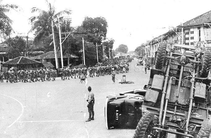 BRITISH PRISONERS-OF-WAR MARCHING ON THE ROAD TO CHANGI