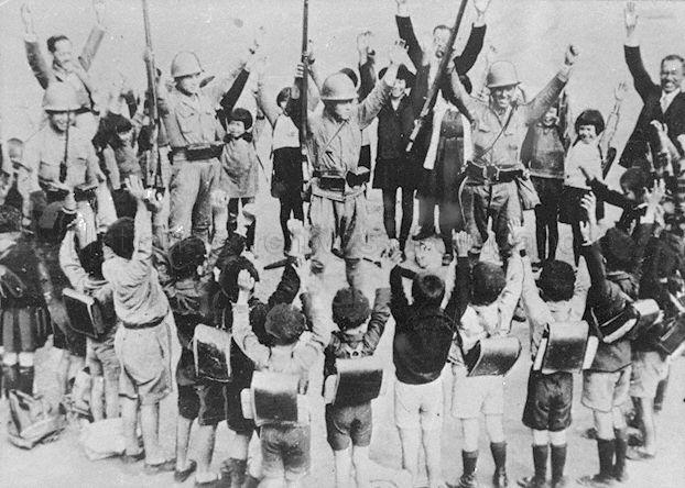 JAPANESE SOLDIERS GREETED BY JAPANESE SCHOOL CHILDREN IN