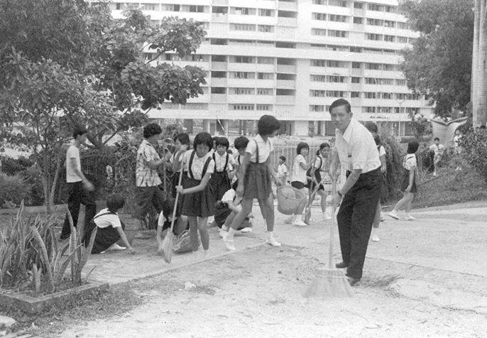 Teachers and students cleaning school compound during "Use