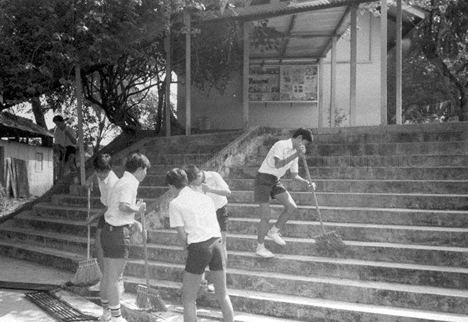 Students sweeping during "Use Your Hands" campaign at