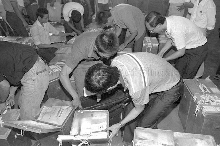 Election Department officials unlocking the boxes of ballot