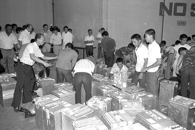 Election Department officials unlocking the boxes of ballot