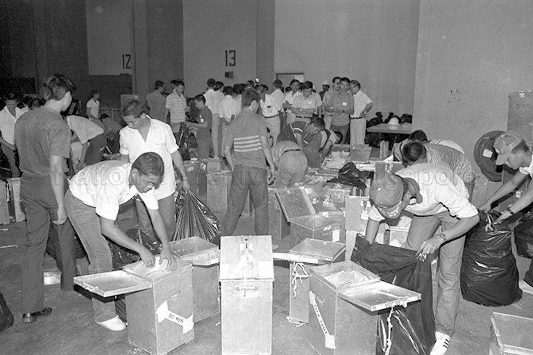 Election Department officials unlocking the boxes of ballot