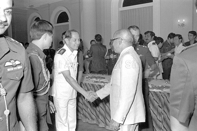 President Devan Nair shaking hands with a senior navy