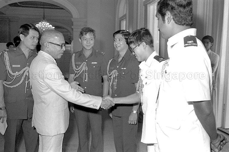 President Devan Nair shaking hands with a newly appointed