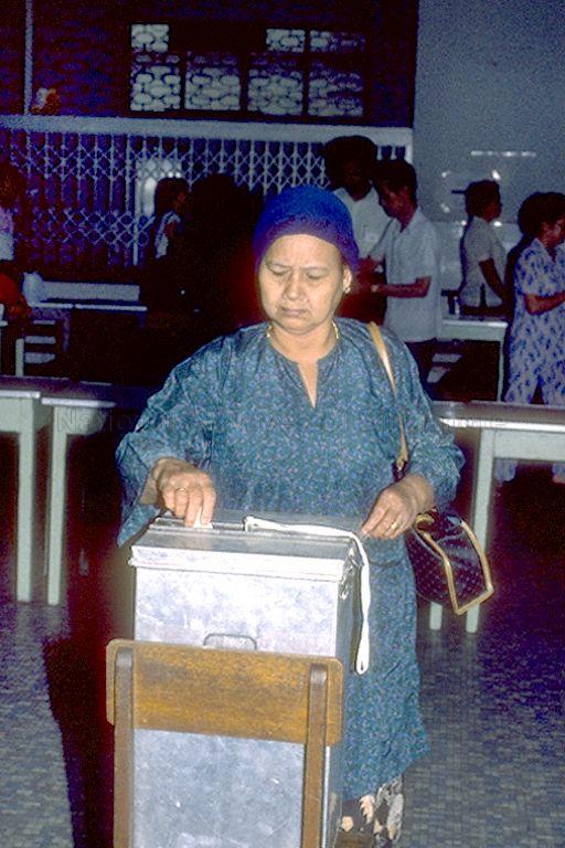 1998 General Election - Voter placing her ballot slip into