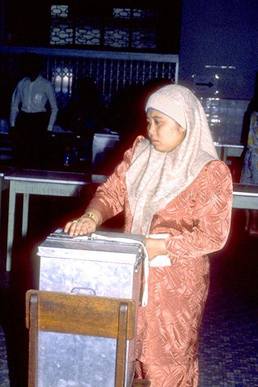 1998 General Election - Voter places her ballot slip into